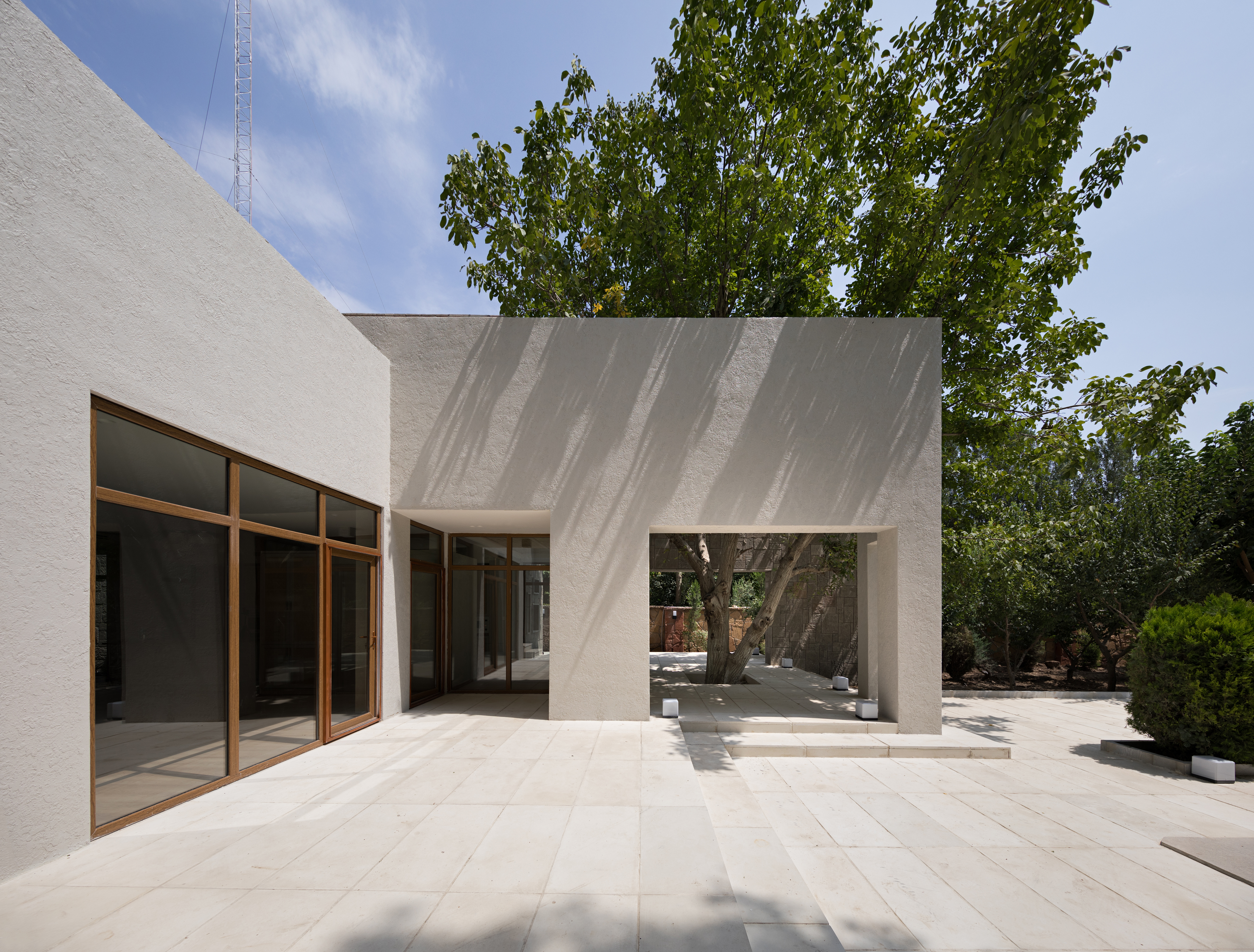 A house between two walnuts by KAV Architects - Architizer
